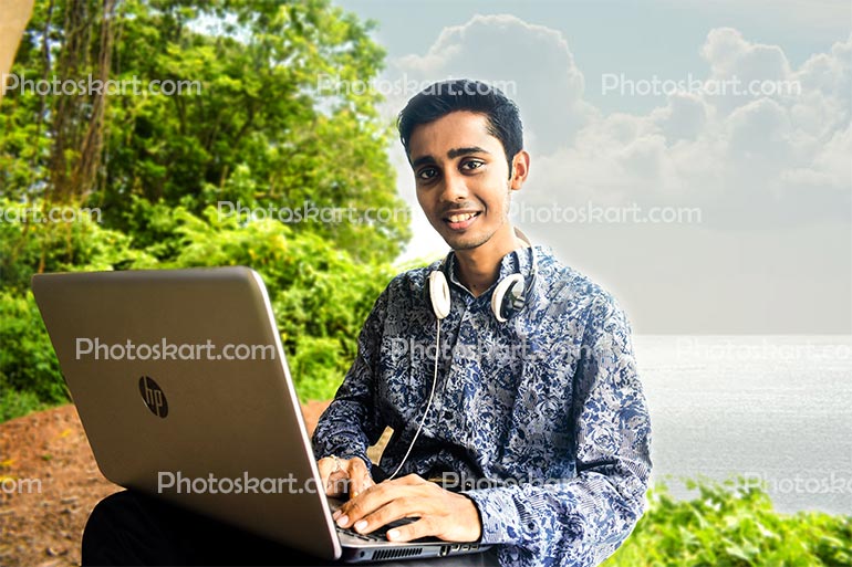 indian college boy beside a river with laptop | Photoskart