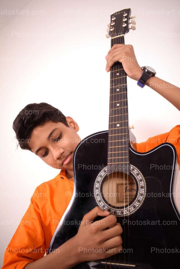 A Teenage Indian Boy Playing Guiter Stock Image